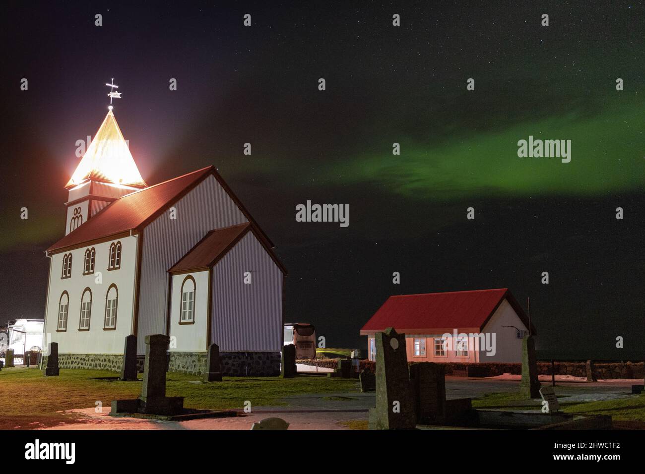 Northern lights over Garður lighthouse & churches Stock Photo - Alamy