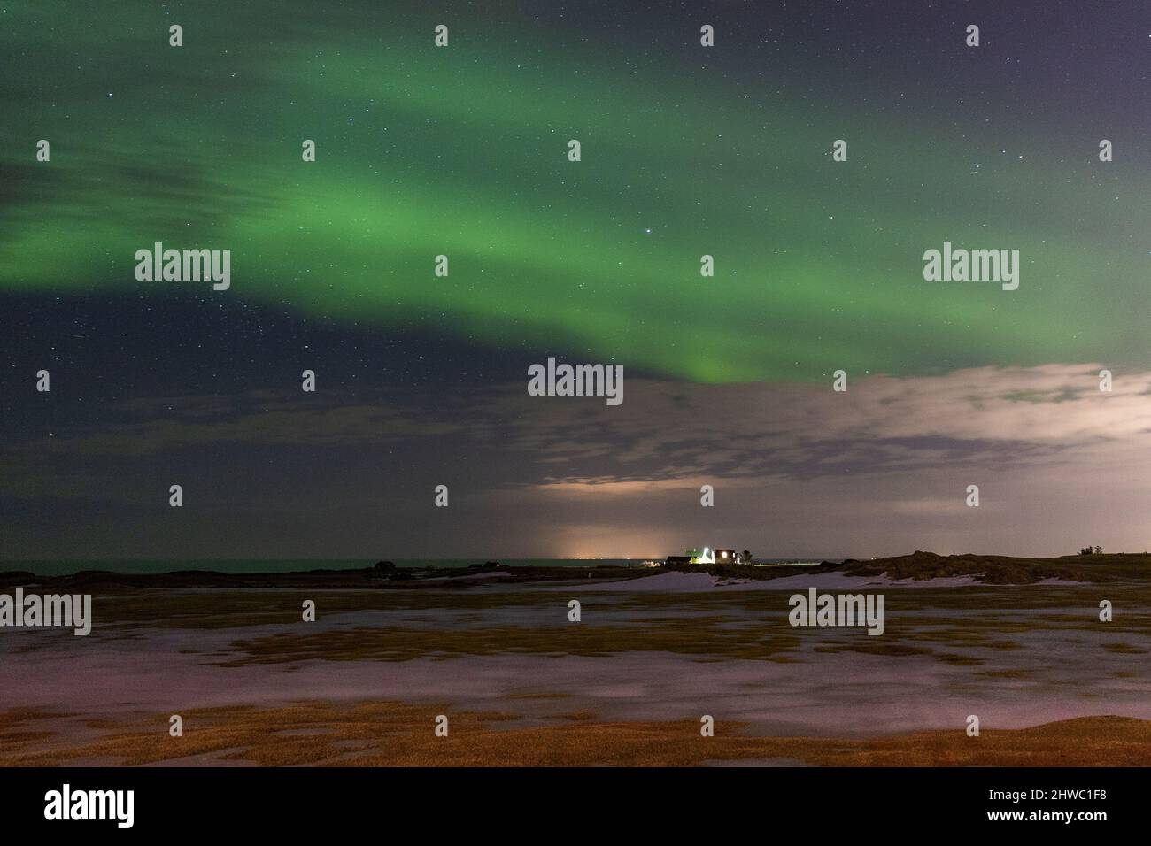 Northern lights over Garður lighthouse & churches Stock Photo - Alamy
