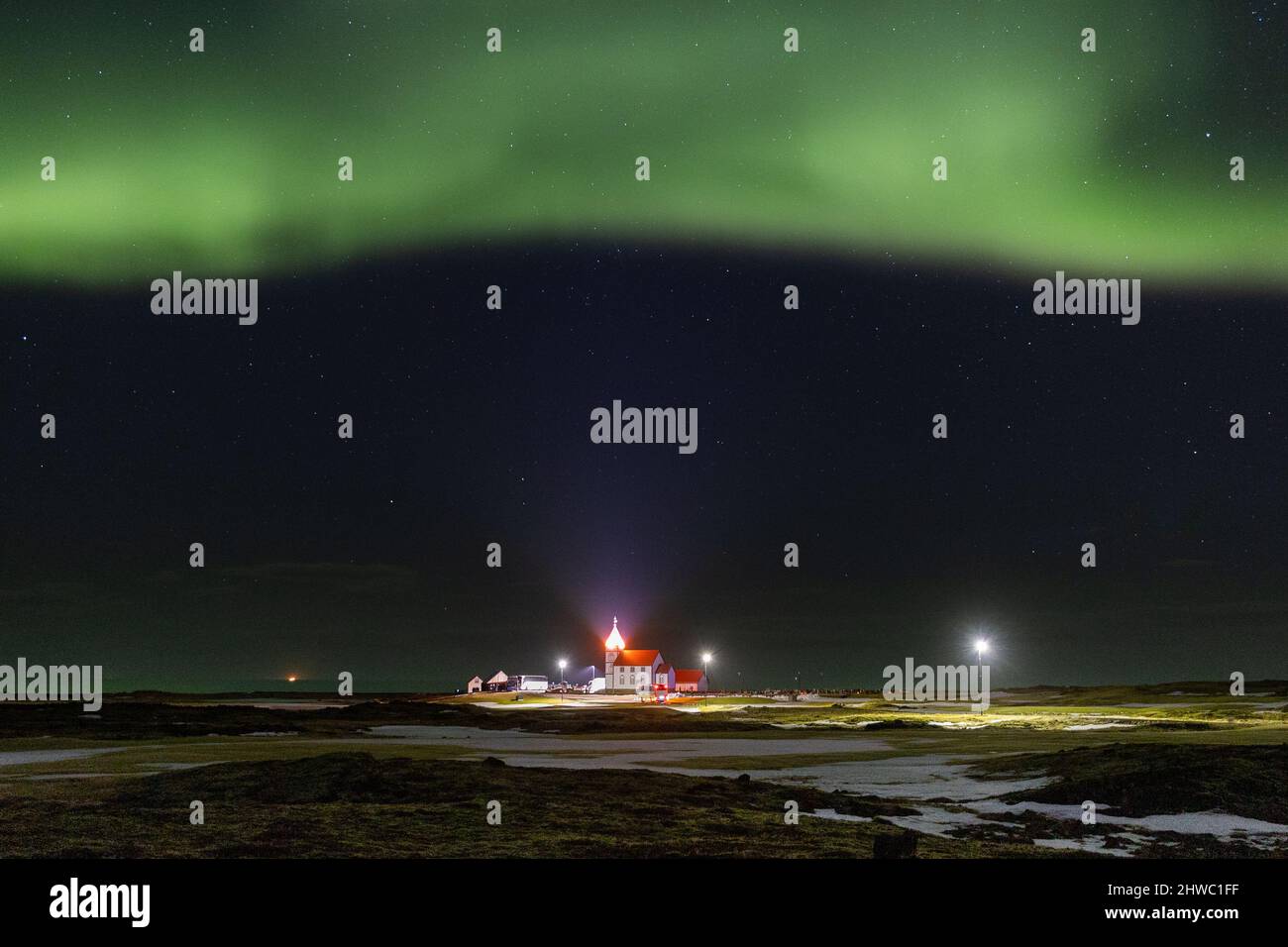 Northern lights over Garður lighthouse & churches Stock Photo - Alamy
