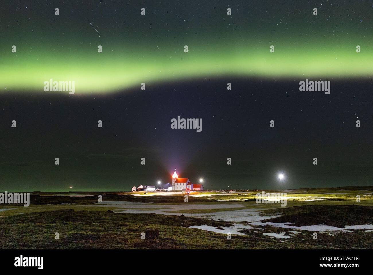 Northern lights over Garður lighthouse & churches Stock Photo - Alamy