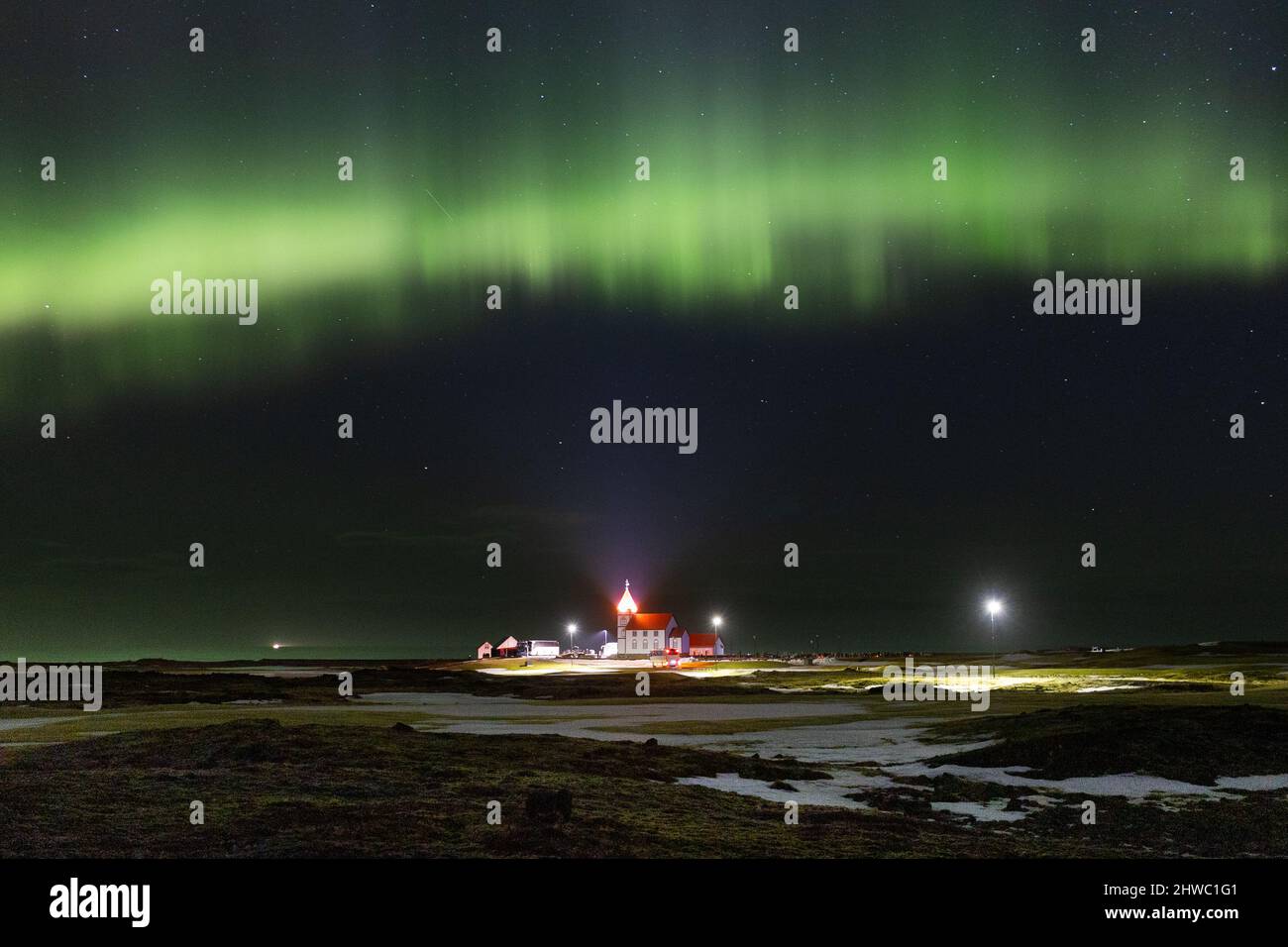 Northern lights over Garður lighthouse & churches Stock Photo - Alamy