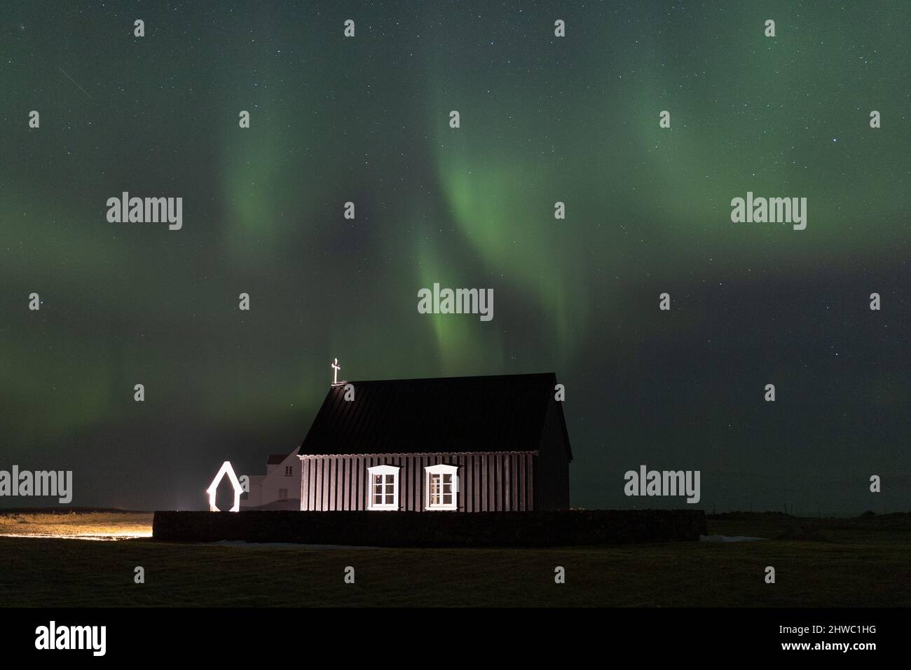 Northern lights over Garður lighthouse & churches Stock Photo - Alamy
