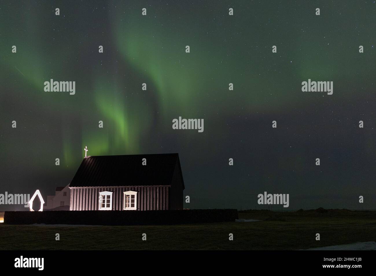 Northern lights over Garður lighthouse & churches Stock Photo - Alamy