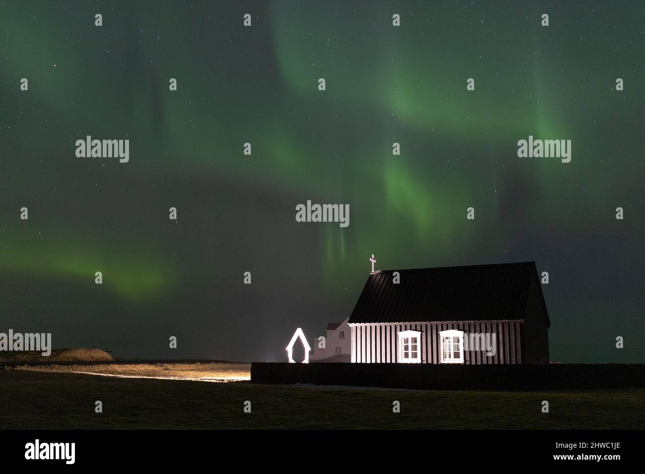 Northern lights over Garður lighthouse & churches Stock Photo - Alamy