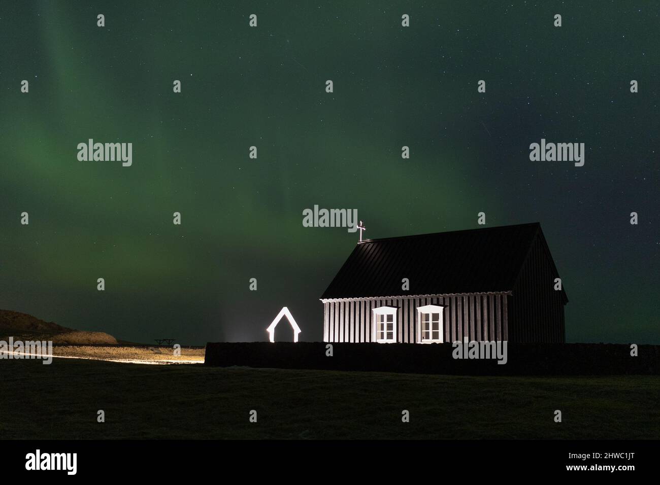 Northern lights over Garður lighthouse & churches Stock Photo - Alamy