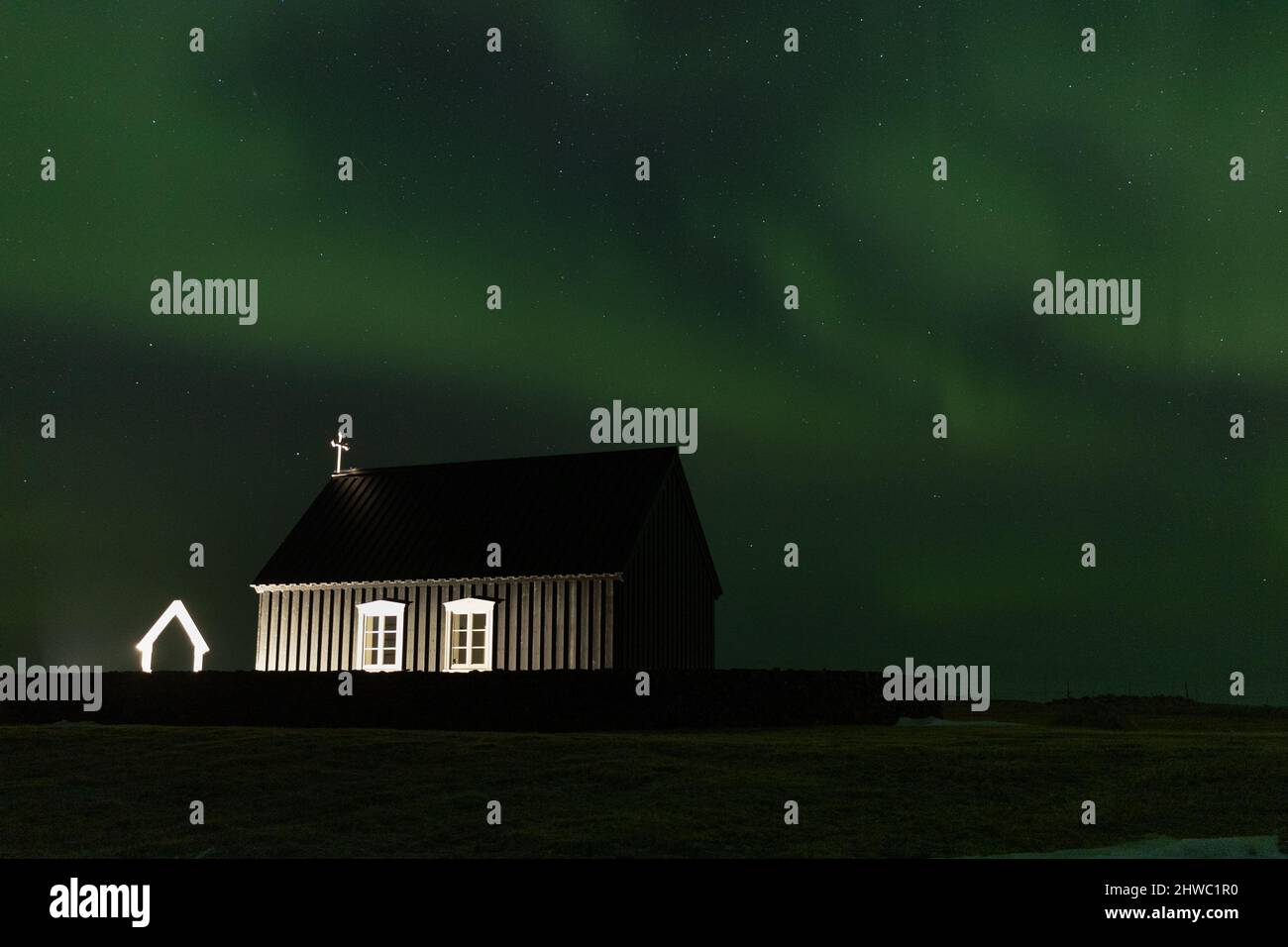 Northern lights over Garður lighthouse & churches Stock Photo - Alamy