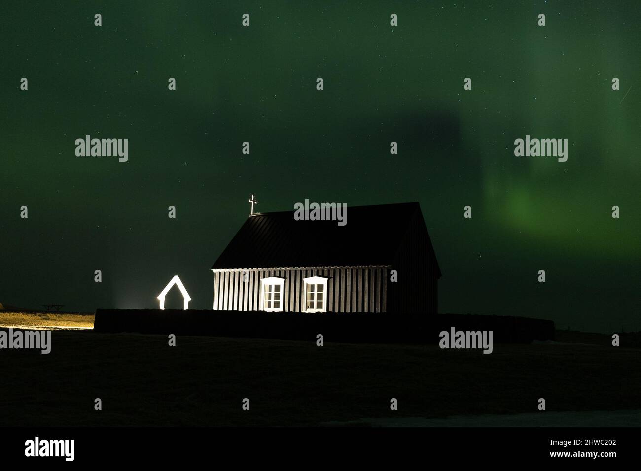 Northern lights over Garður lighthouse & churches Stock Photo - Alamy