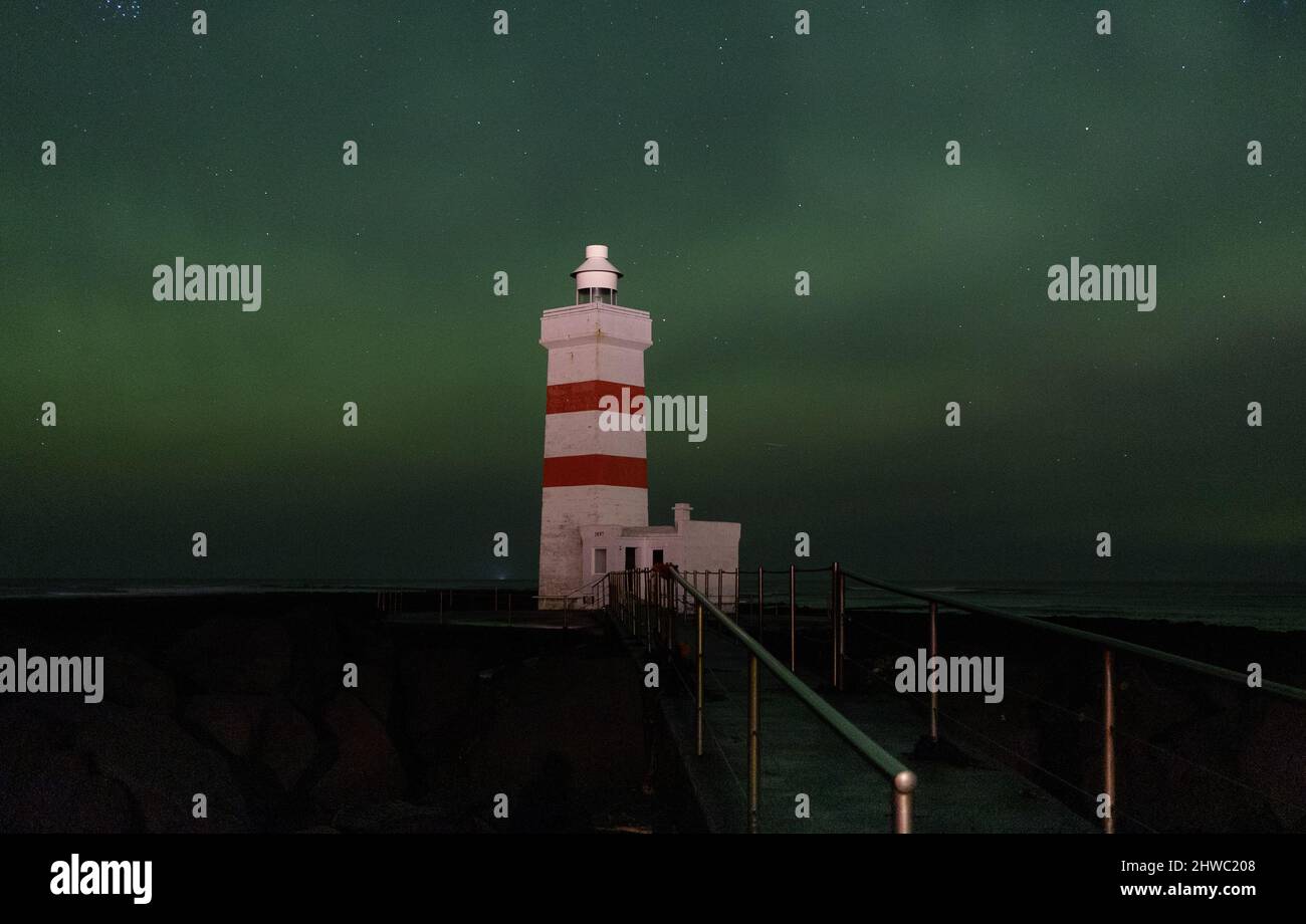 Northern lights over Garður lighthouse & churches Stock Photo - Alamy