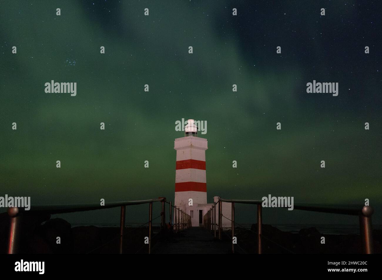Northern lights over Garður lighthouse & churches Stock Photo - Alamy