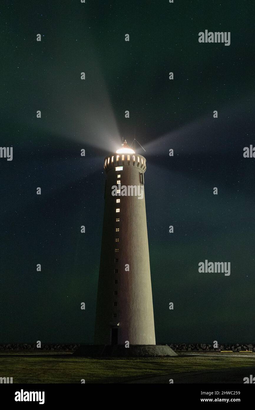 Northern lights over Garður lighthouse & churches Stock Photo - Alamy