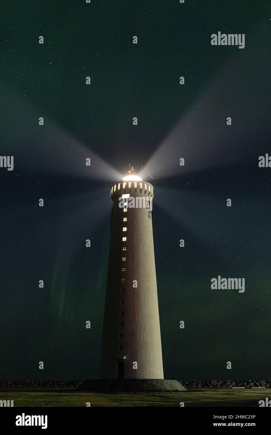 Northern lights over Garður lighthouse & churches Stock Photo - Alamy