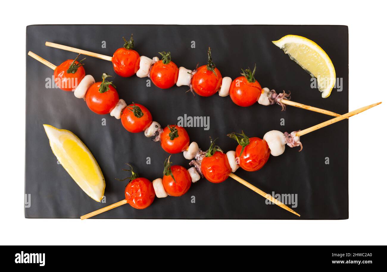 Skewers with roasted mini calamari and cherry tomatoes with lemon ...