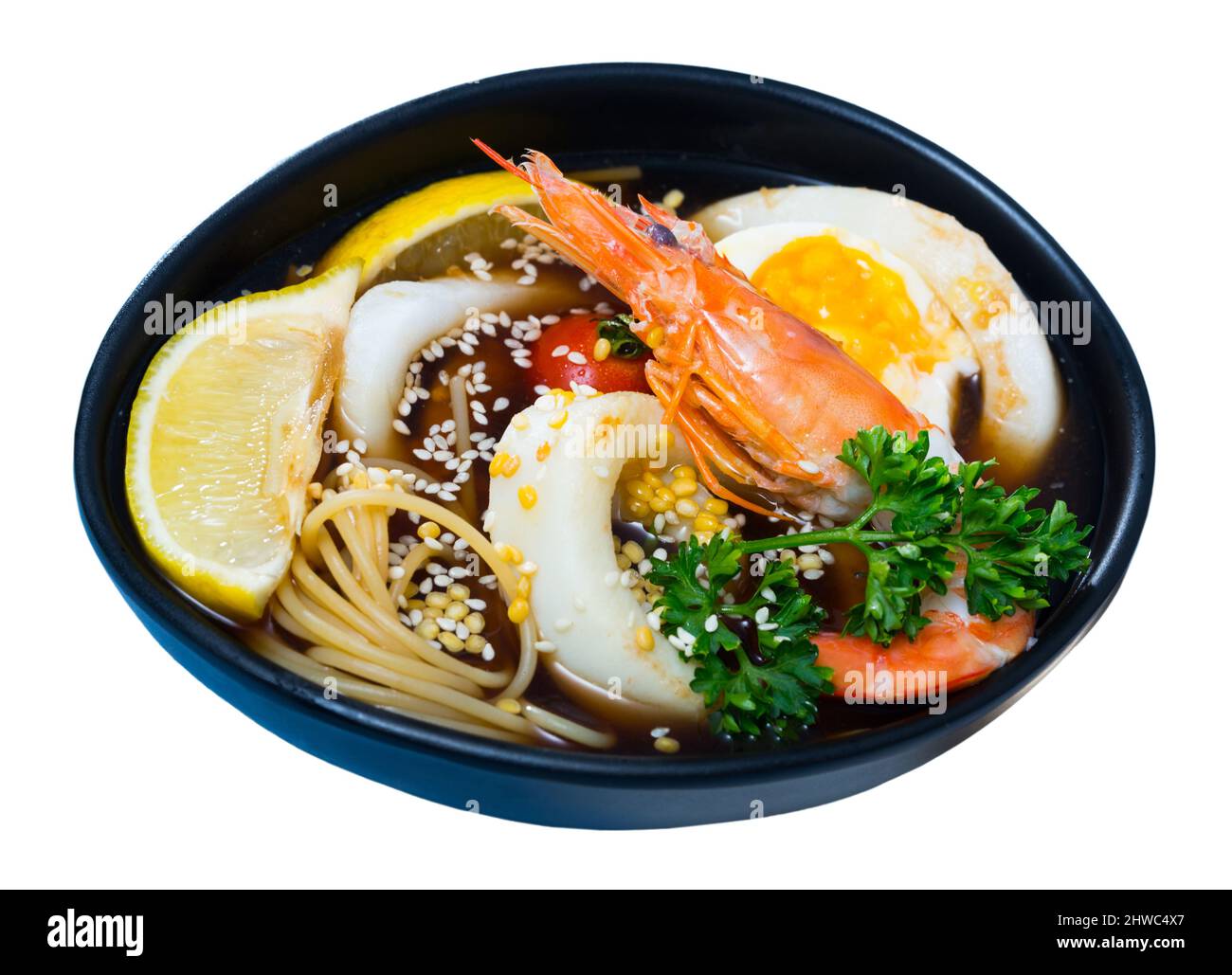 Spicy Pan-Asian soup with squid, shrimp, egg noodles and sesame ...