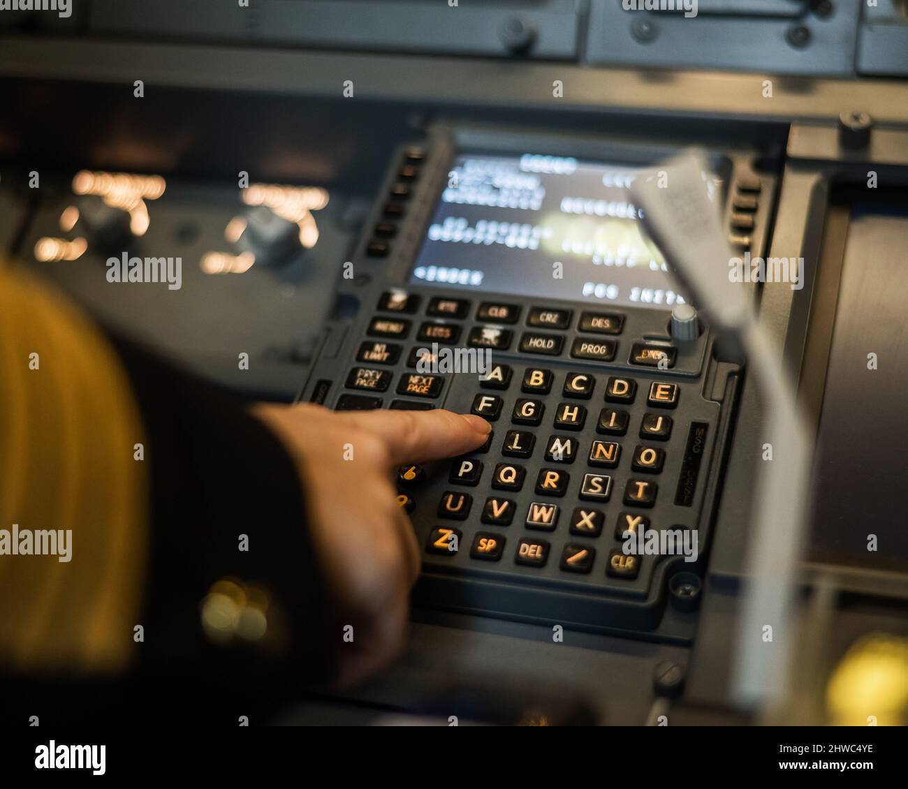 Female pilot inserting flight information into plane system. Airplane ...