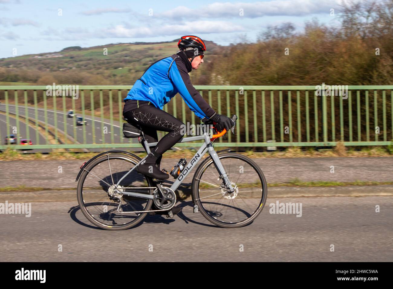 Male cyclist riding Dolan sports road bike on countryside route ...