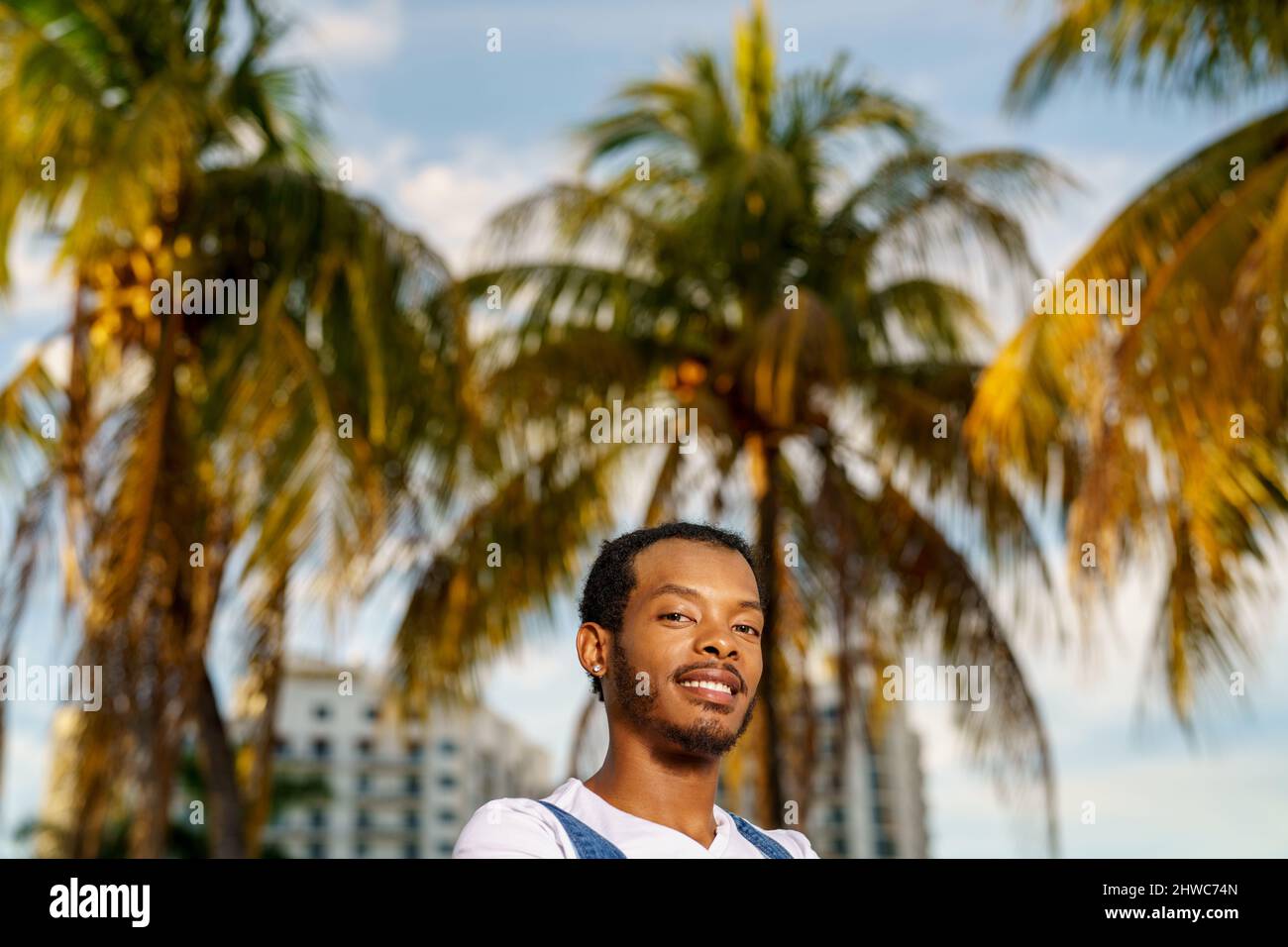 Portrait photo of a man in the park with palm trees in background Stock ...