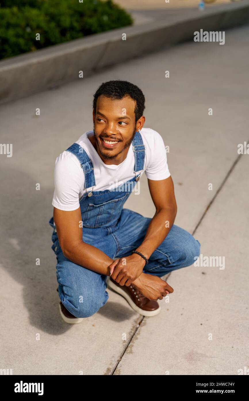 Man squatting in denim hi-res stock photography and images - Alamy