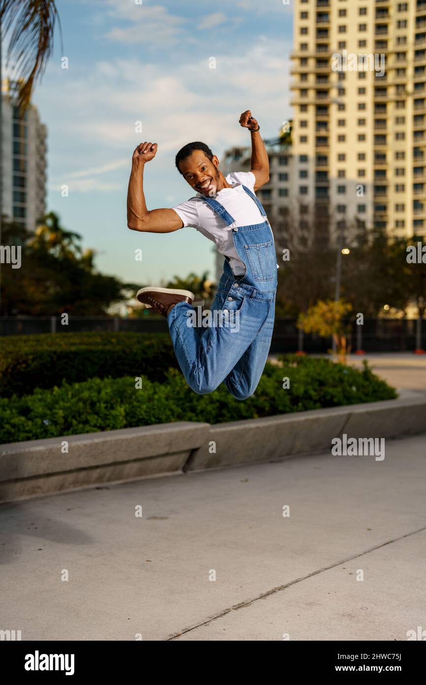 Midair photo of a man jumping and smiling Stock Photo - Alamy
