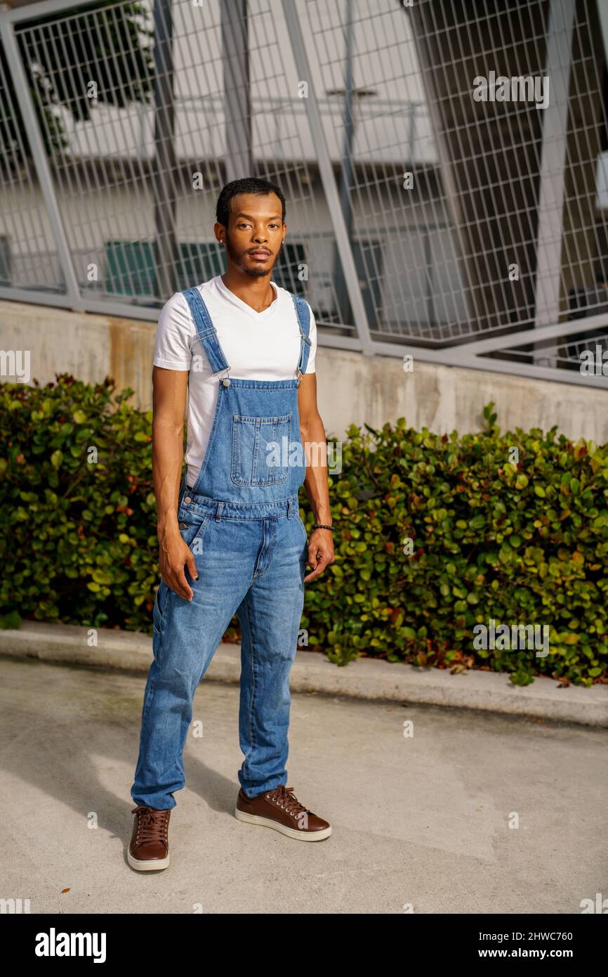 Photo of a handsome man posing in overalls Stock Photo - Alamy