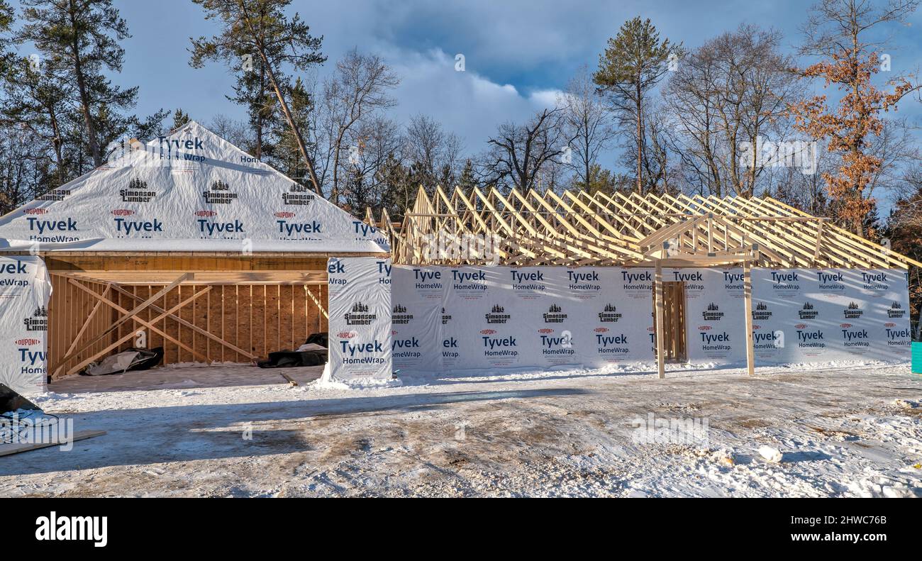 NISSWA, MN - 22 NOV 2021: Home construction site in winter, with Tyvek ...