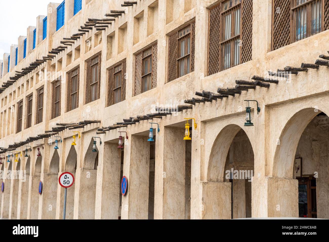 Middle eastern architecture with bamboo wooden poles sticking out of a ...