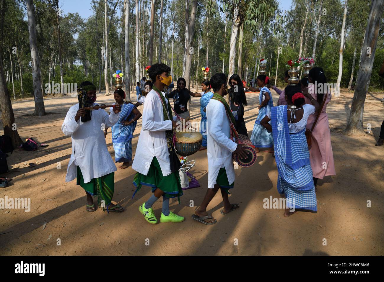 Tourists are dancing and singing with local traditional dressed Santali ...