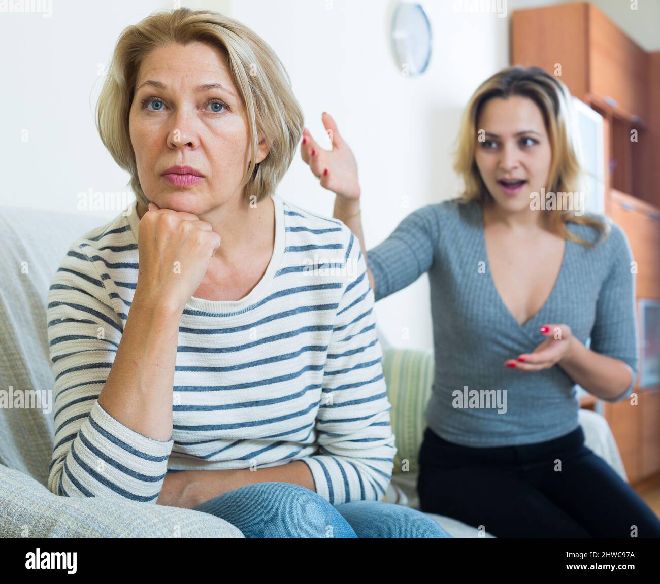 Adult Daughter Screaming At Senior Mother During Quarrel Indoor Stock