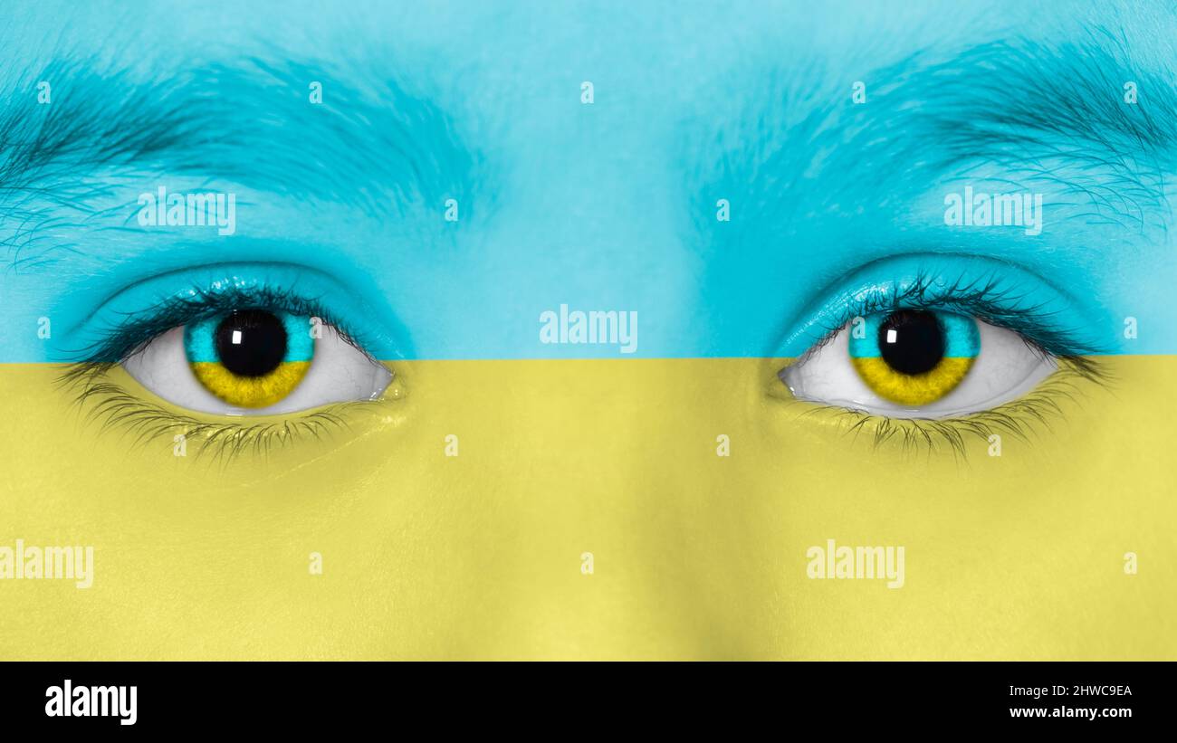 Teen Girl's eyes and face are toned in colors of Ukrainian Flag. Stop ...