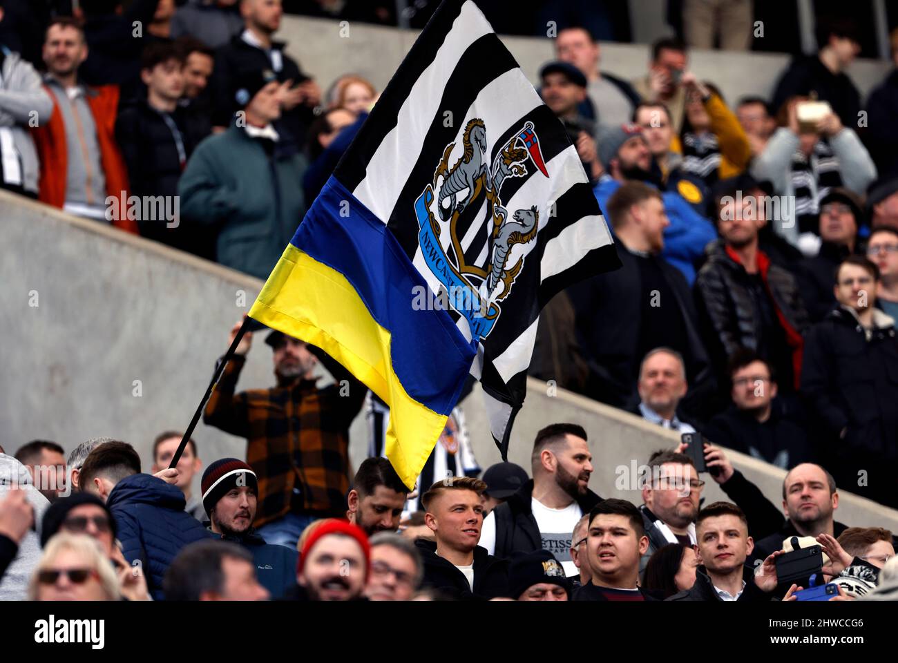 Newcastle United fans in the stands with flags and the colours of ...