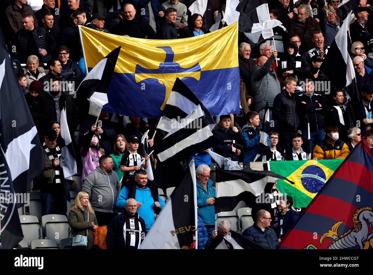 Newcastle United fans in the stands with flags and the colours of ...