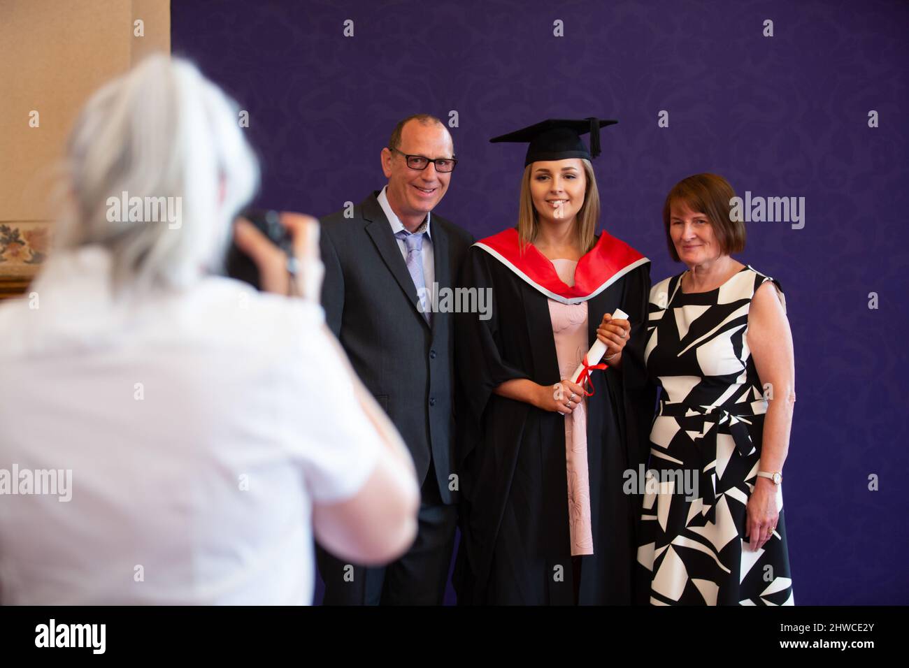 A pretty European Graduate poses with her family for the official ...