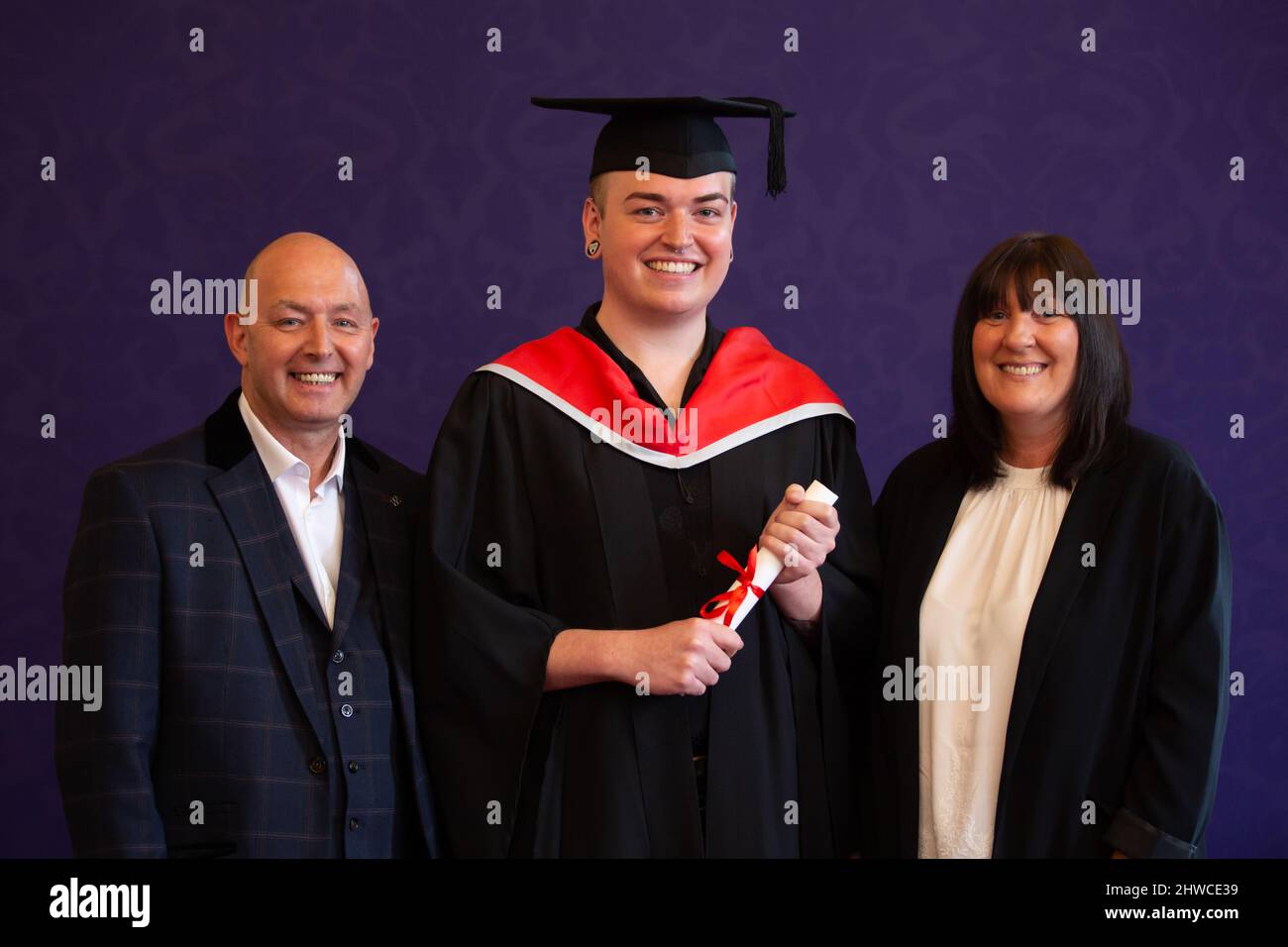 A European Graduate poses with family for the official photographer at ...