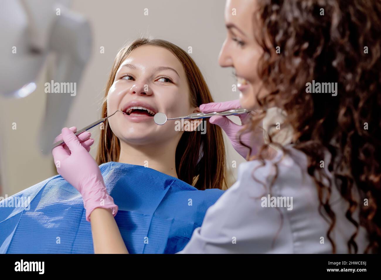 Professional doctor dentist examine and treat spoiled teeth with the ...