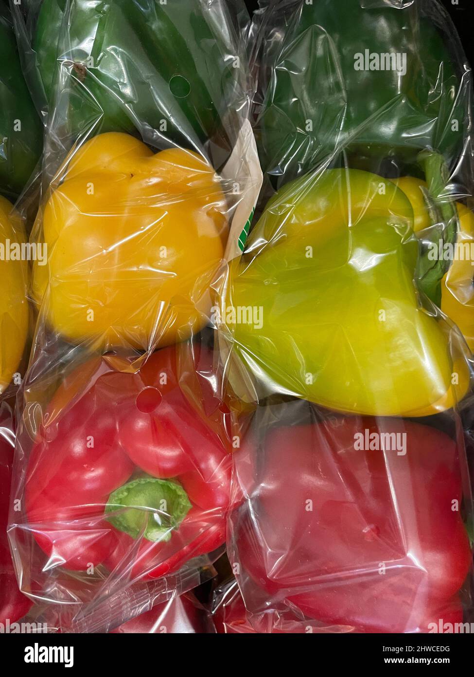 Bell pepper in plastic film in supermarket Stock Photo - Alamy