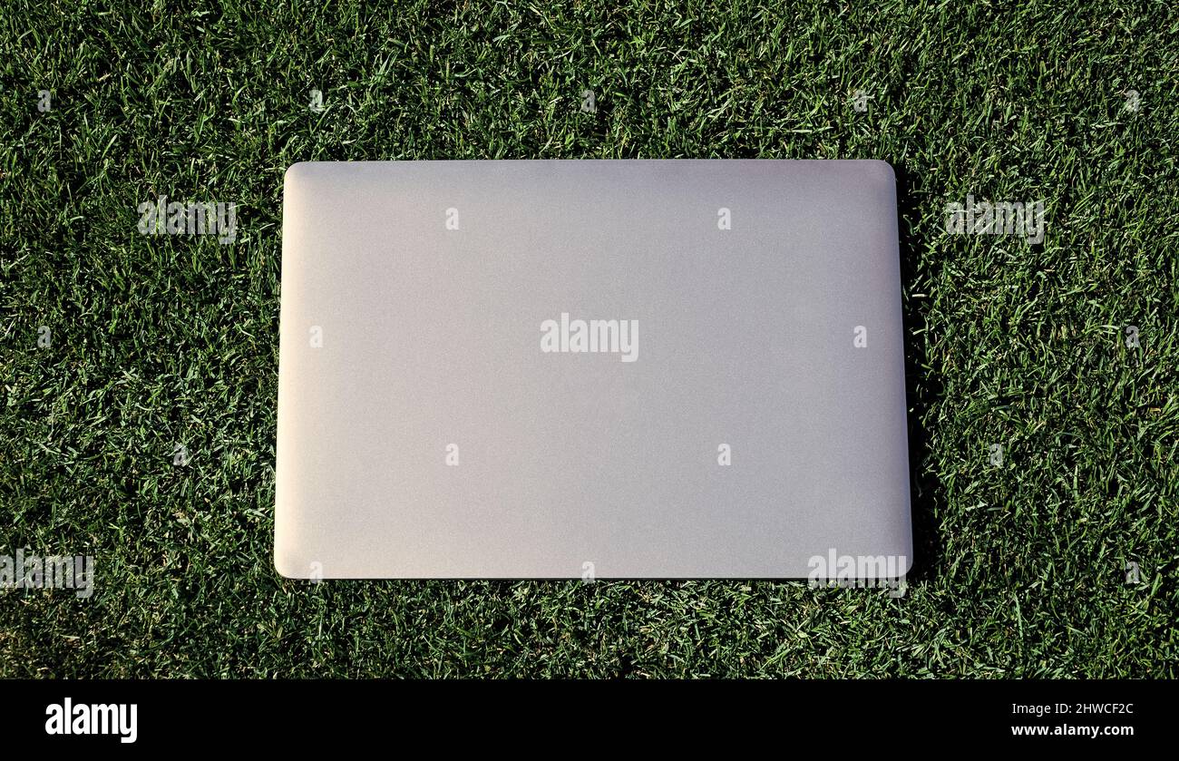 laptop on green grass. agile business. distance learning concept ...