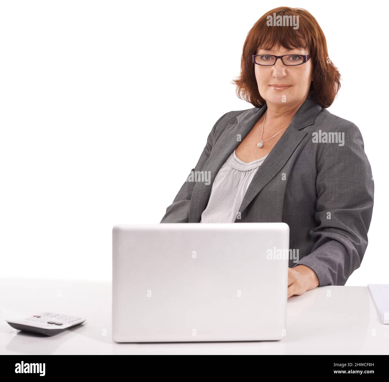 Im the boss around here. A business woman sitting at her desk with a ...