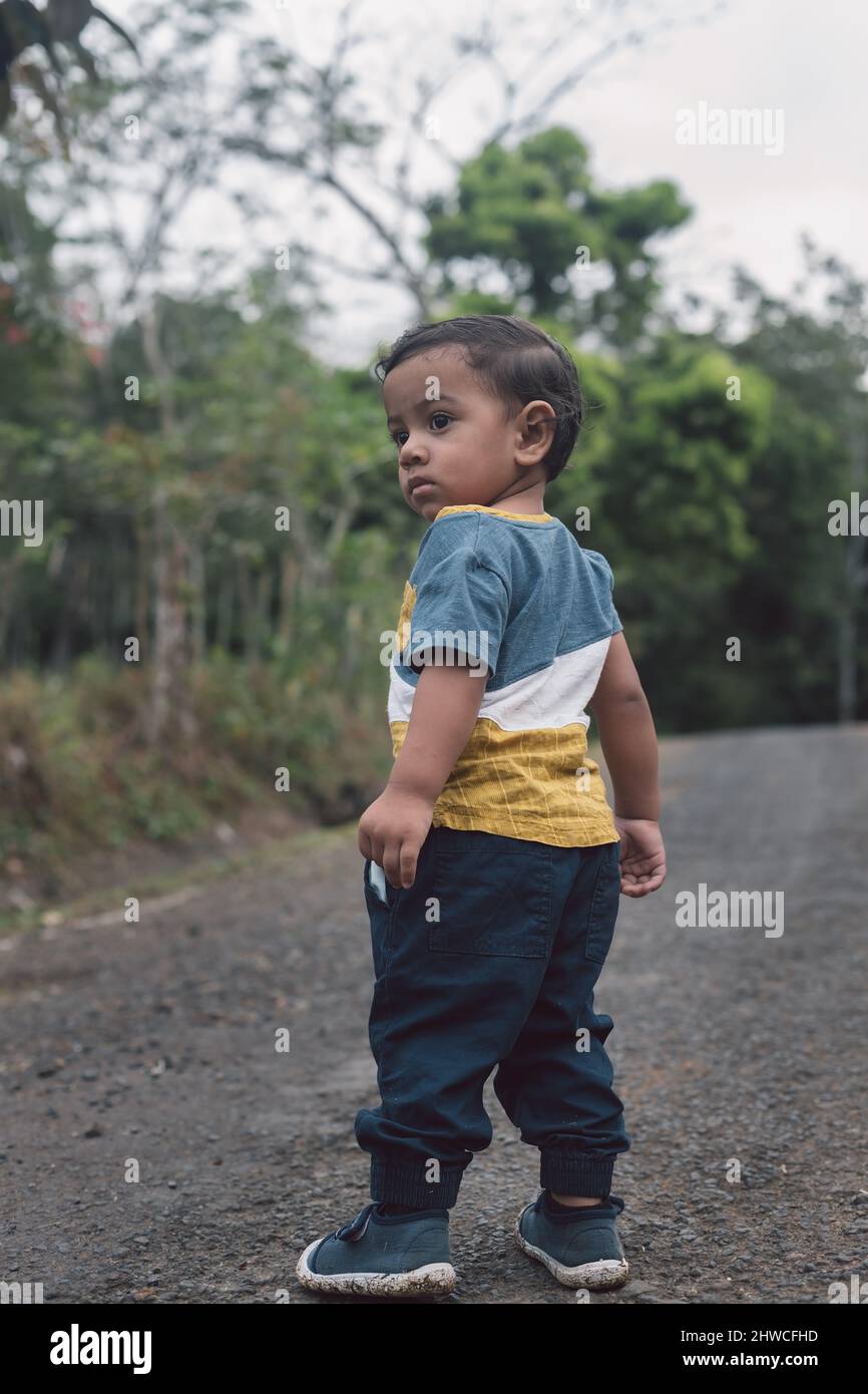 child walking down the road, baby looking back on the street Stock ...