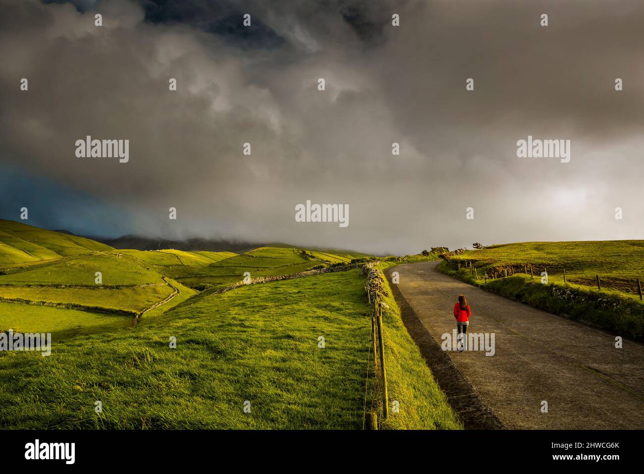 Woman standing on a top of a clif and enjoying the view Stock Photo - Alamy