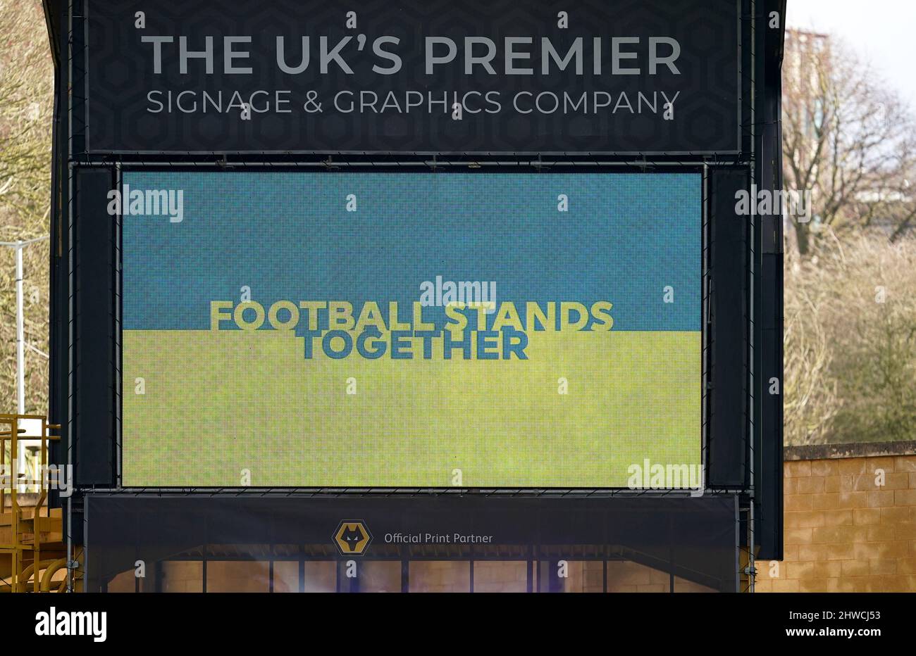 The big screen displays 'Football Stands Together' as players from ...