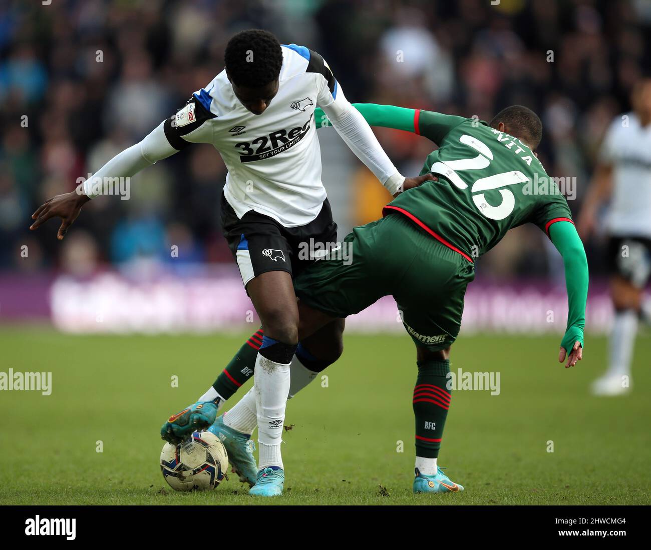 Derby County's Malcolm Ebiowei (left) and Barnsley's Remy Vita battle ...