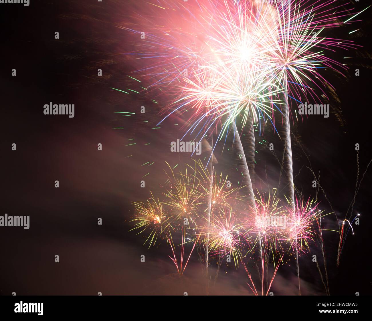 Colorful fireworks display on night sky background Stock Photo - Alamy