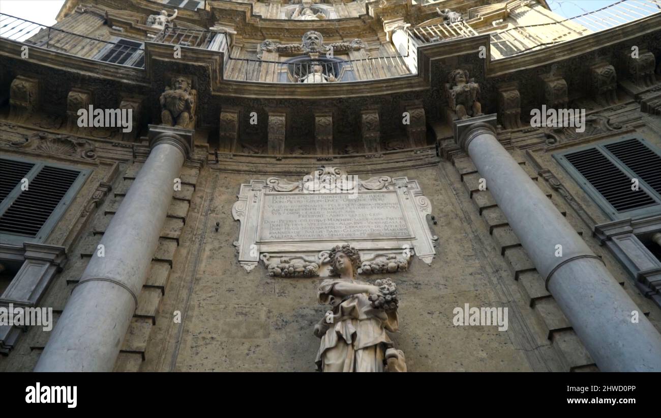View from below on facade of ancient building with statues and details ...
