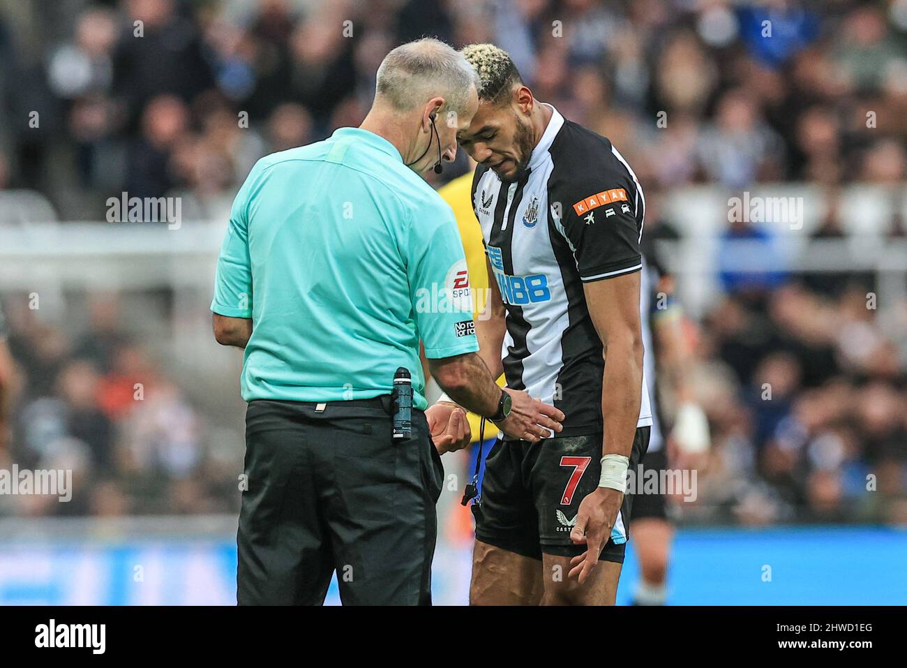 Referee Martin Atkinson checks Joelinton #7 of Newcastle United’s ...