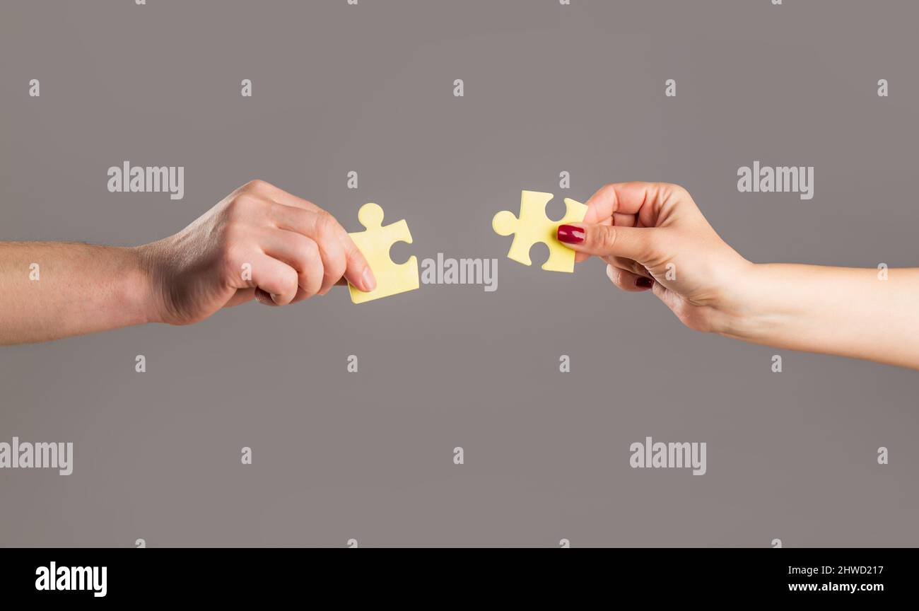 Hands hold puzzles. Solution of problems. Mens and childs hands ...