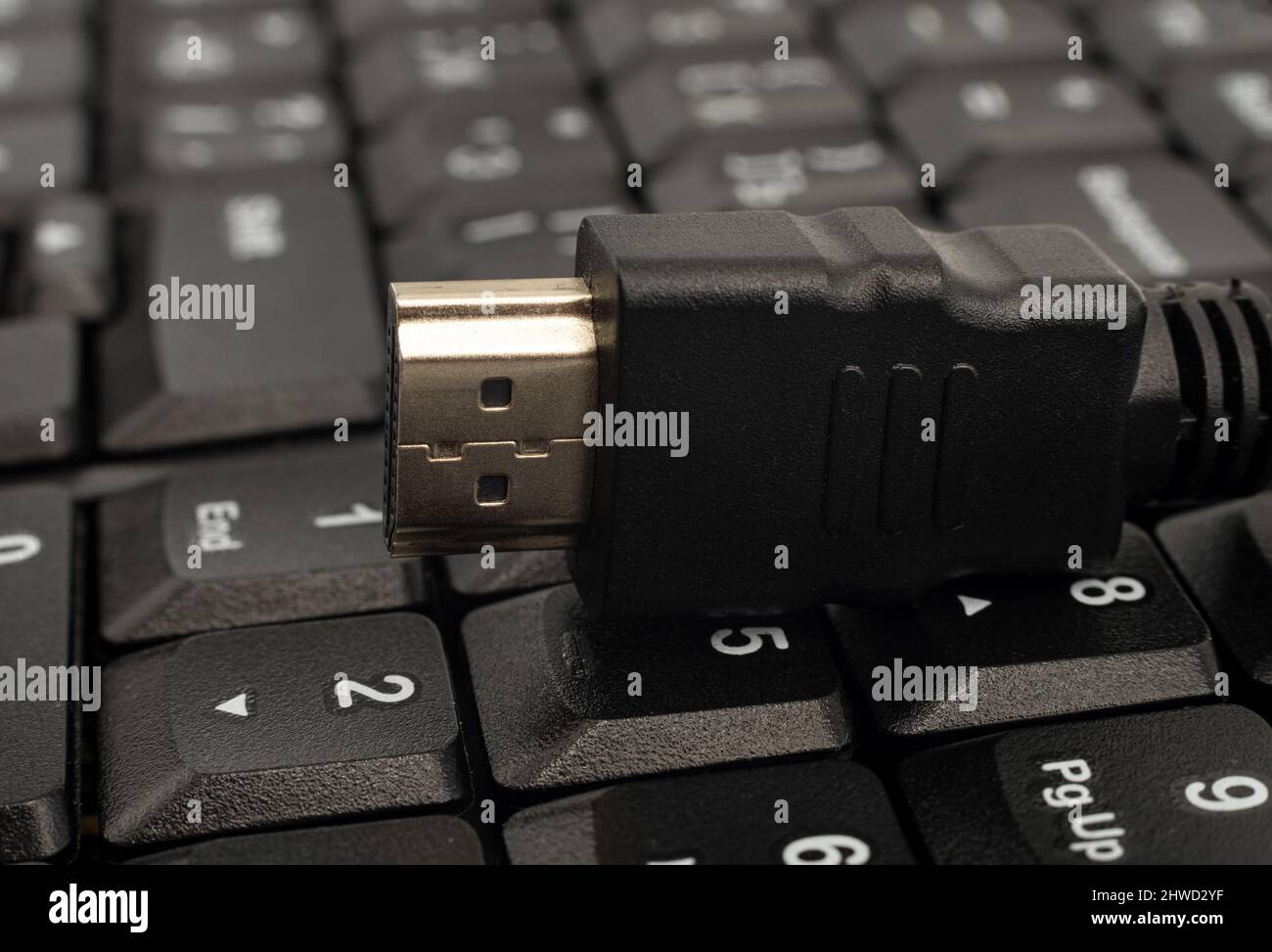 hdmi cable lies on a wireless keyboard close-up. TV connection cable ...