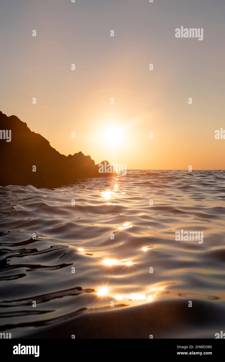 Sunset with yellow sun at the horizon at sea Stock Photo - Alamy