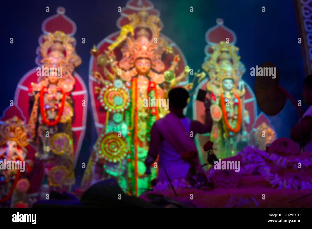 Blurred image of Goddess Durga , being worshipped by Hindu priest with ...
