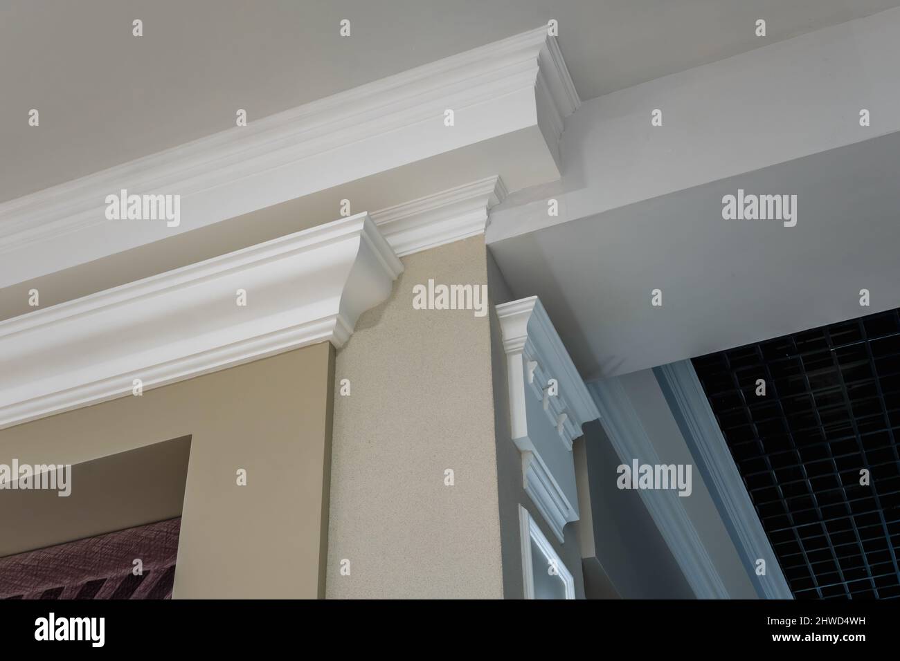 Detail of corner ceiling with intricate crown molding on column with ...