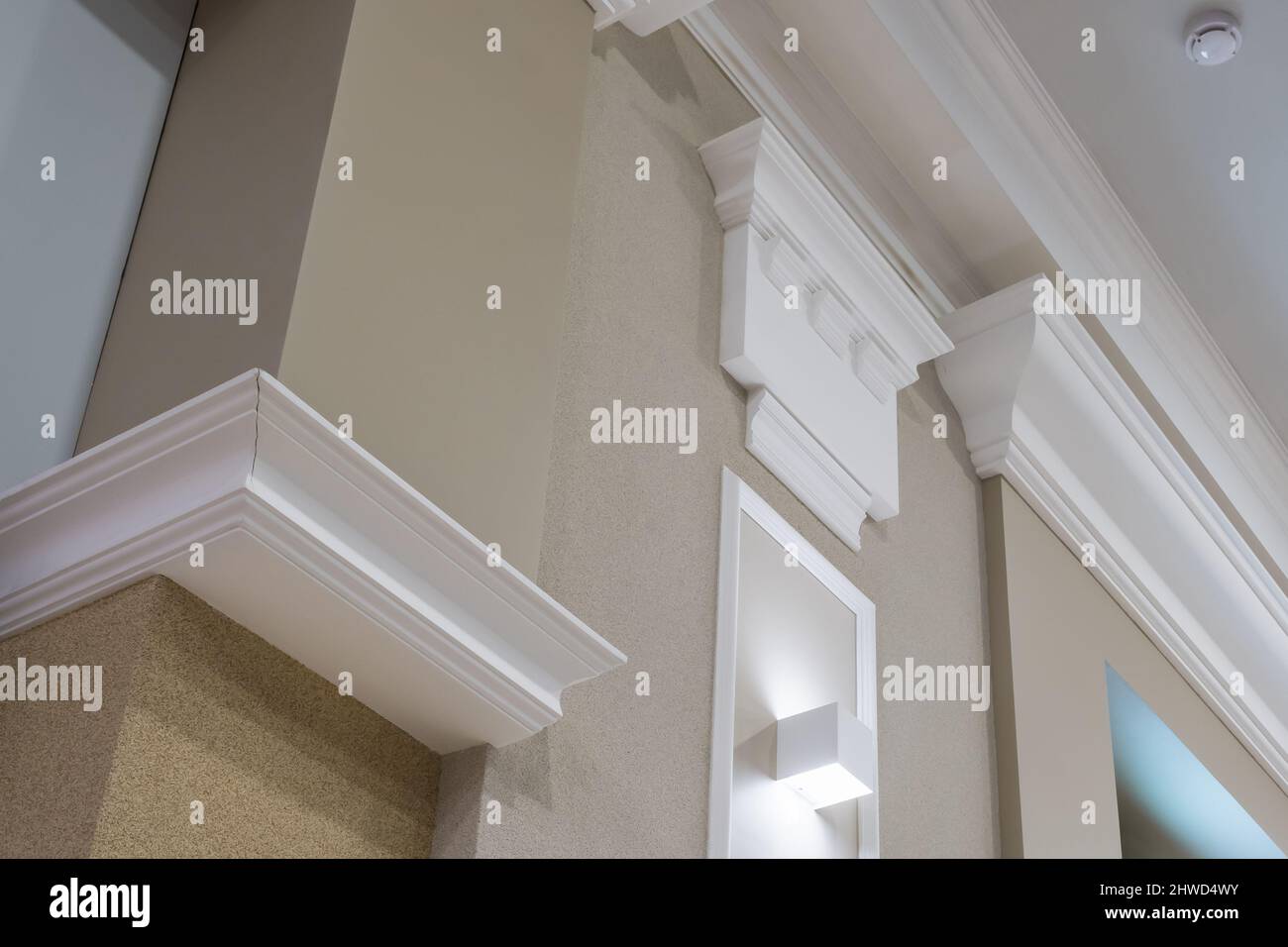 Detail of corner ceiling with intricate crown molding on column with ...