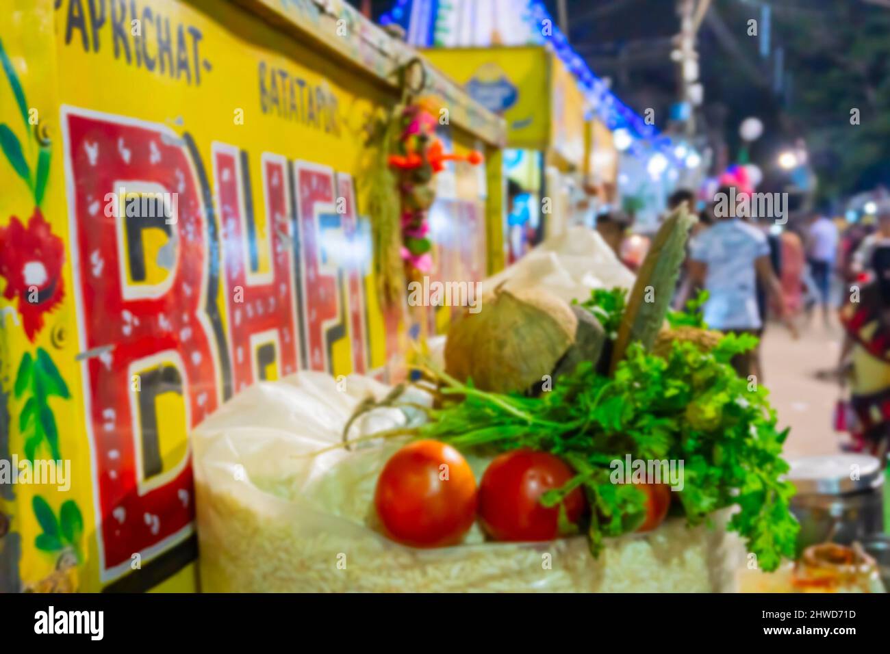 Blurred image of Murhi, narkol, tomato, dhonepata - Ingredients of ...